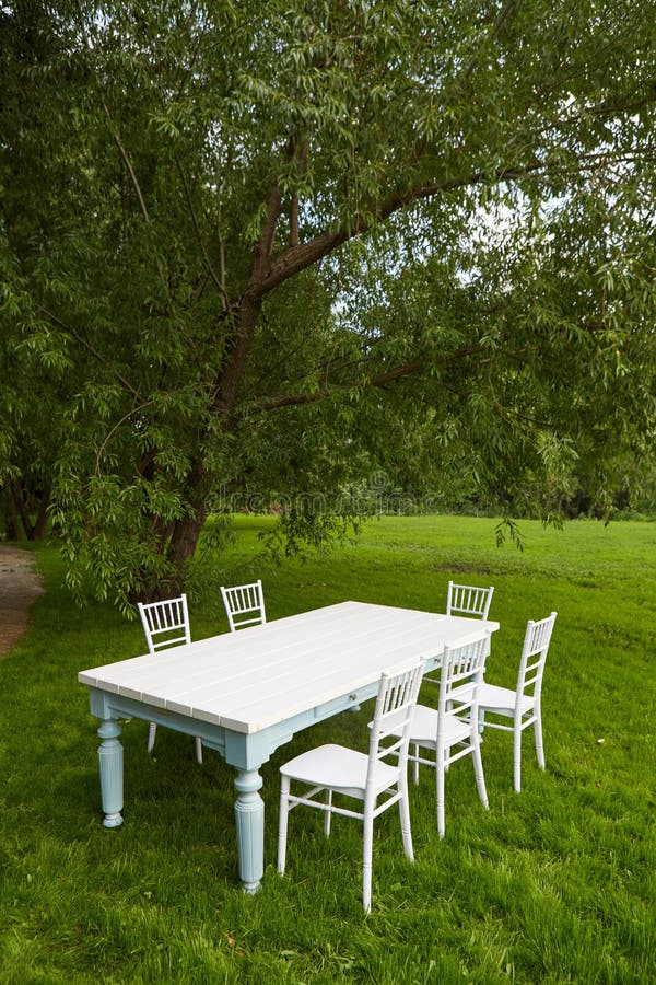 White Table with Chairs Under Tree on Lawn Stock Image - Image of ...