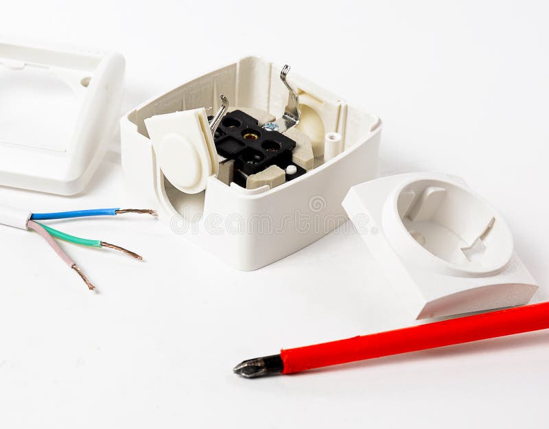 On a White Table, a Disassembled Electrical Outlet Ready To Install ...