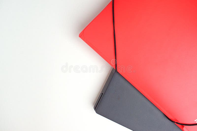 On a White Table, the Edge of a Gray Laptop and a Red Folder. Online ...
