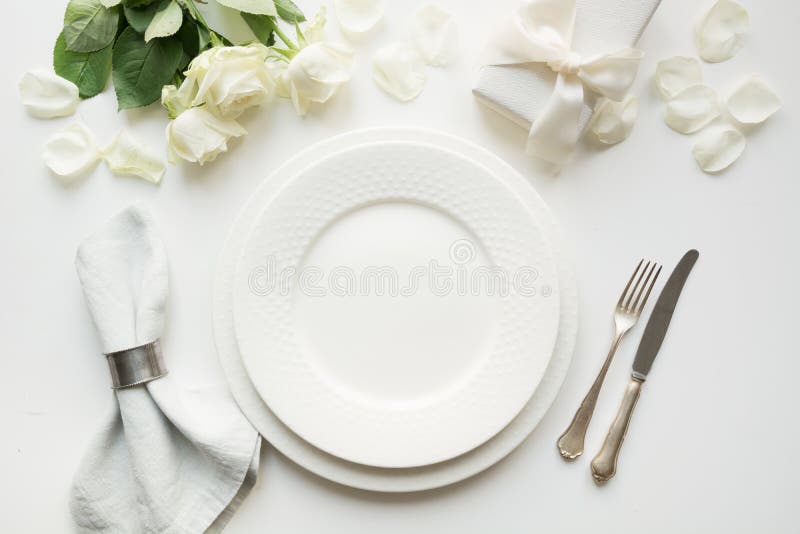 White Table Setting with Bouquet Rose, Gift, Dishware, Silverware on ...