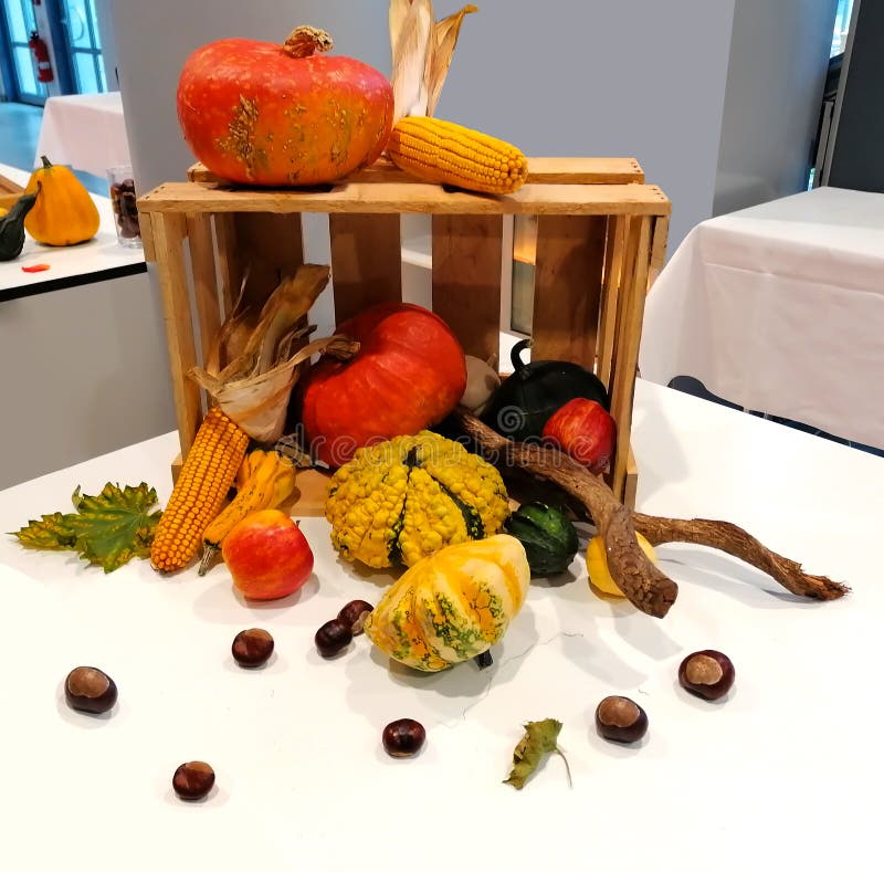 Composition with Vegetables and Fruits on a Box on a Table with a White ...