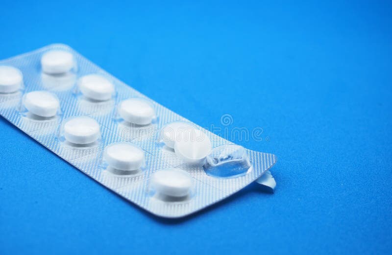 White Tablets on a Blue Background. One Tablet without Packaging, the ...