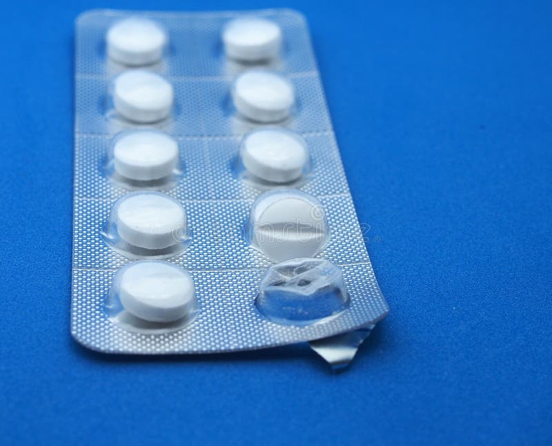 White Tablets on a Blue Background. One Tablet without Packaging, the ...