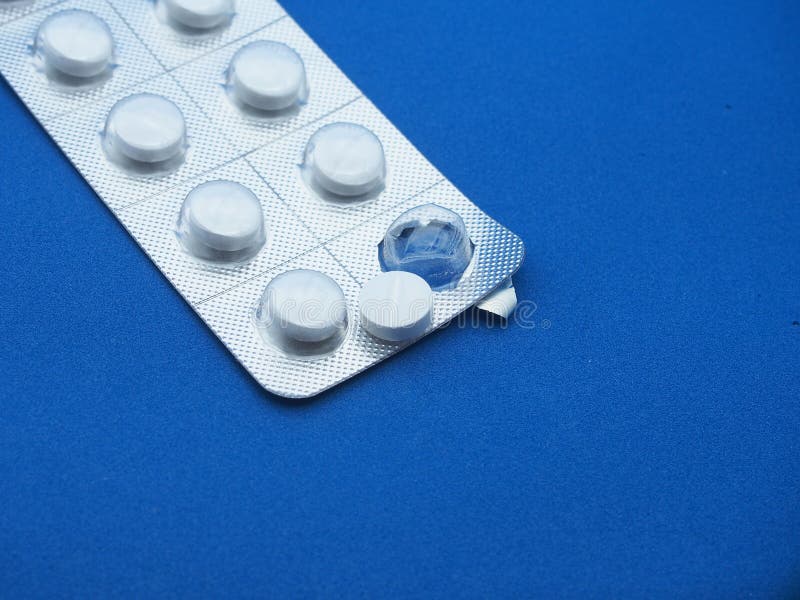 White Tablets on a Blue Background. One Tablet without Packaging, the ...