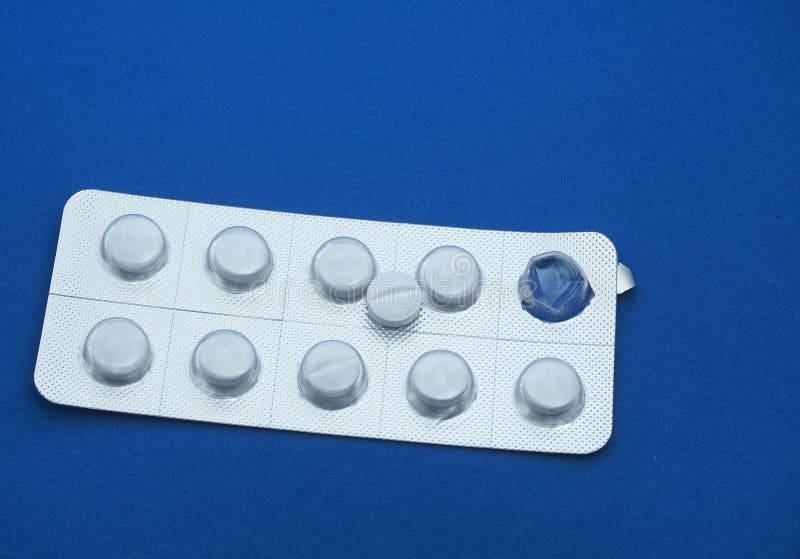 White Tablets on a Blue Background. One Tablet without Packaging, the ...