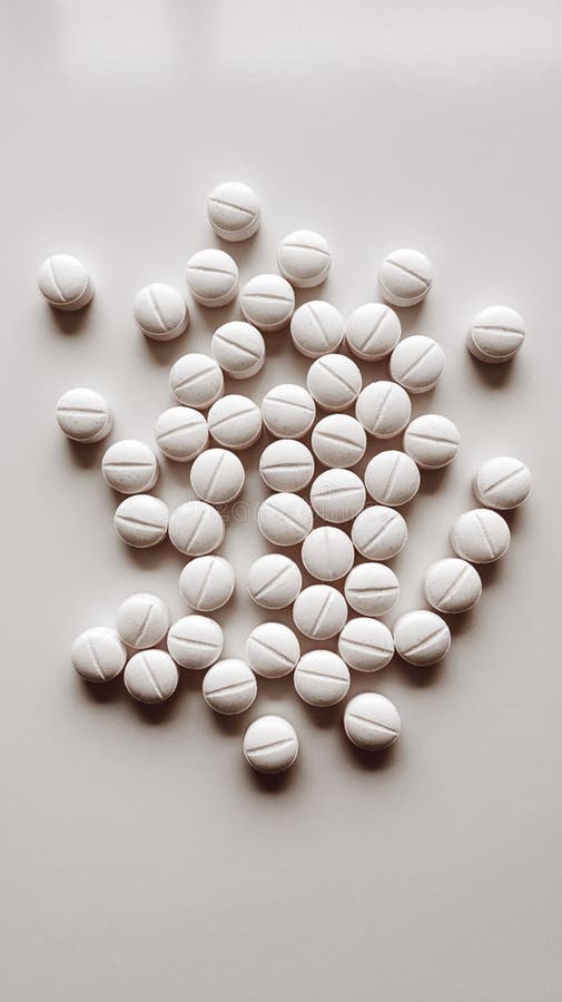 White Tablets Scattered on Surface, Evoking Clinical Simplicity and ...