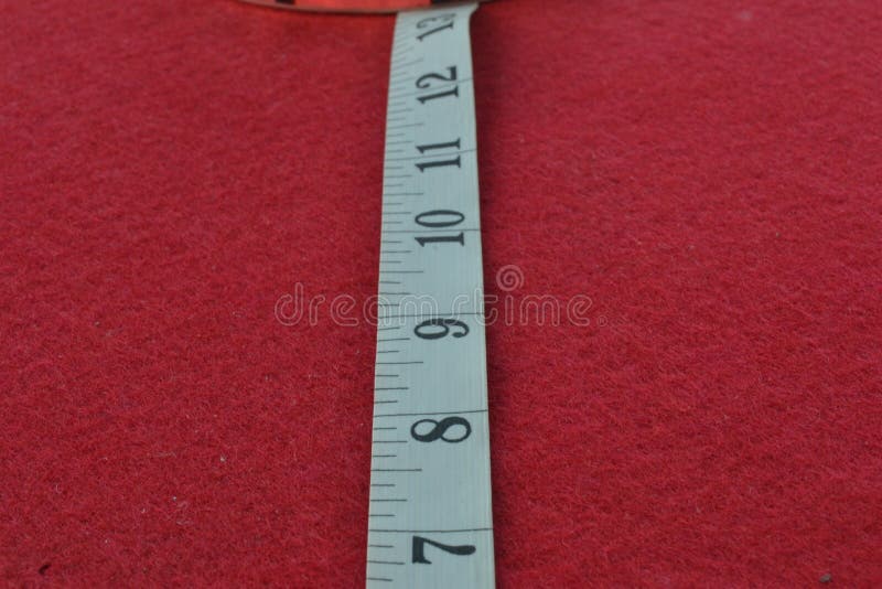 White Tape Measure on a Red Background with the Numbers Stock Image ...