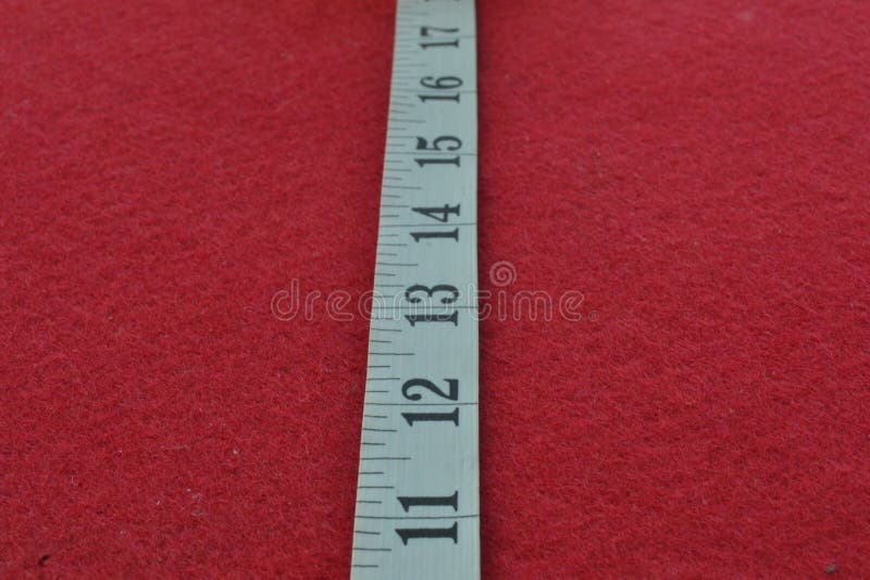 White Tape Measure on a Red Background with the Numbers Stock Photo ...
