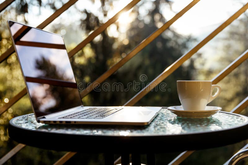 White Tea or Coffee Mug and a Laptop on a Balcony Coffee Table Stock ...