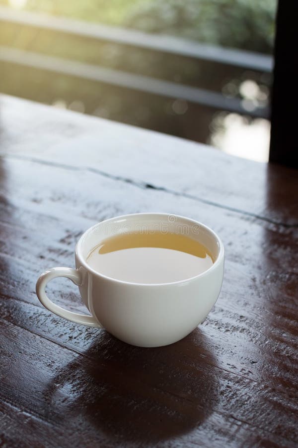 Teacup on a wooden table stock photo. Image of cold - 128227608