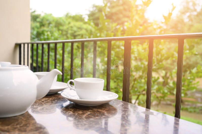 White Teapot and Cup of Tea on Table. Outdoor Breakfast on Balcony Cafe ...