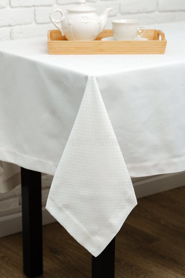 White Textured Tablecloth Draped Over Black Table Leg Stock Photo ...