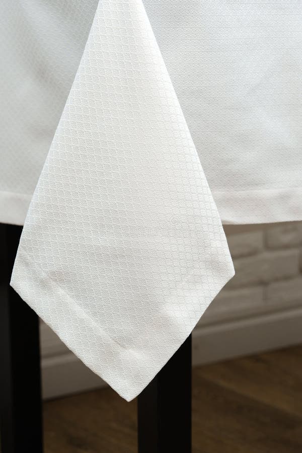 White Textured Tablecloth Draped Over Black Table Leg Stock Photo ...