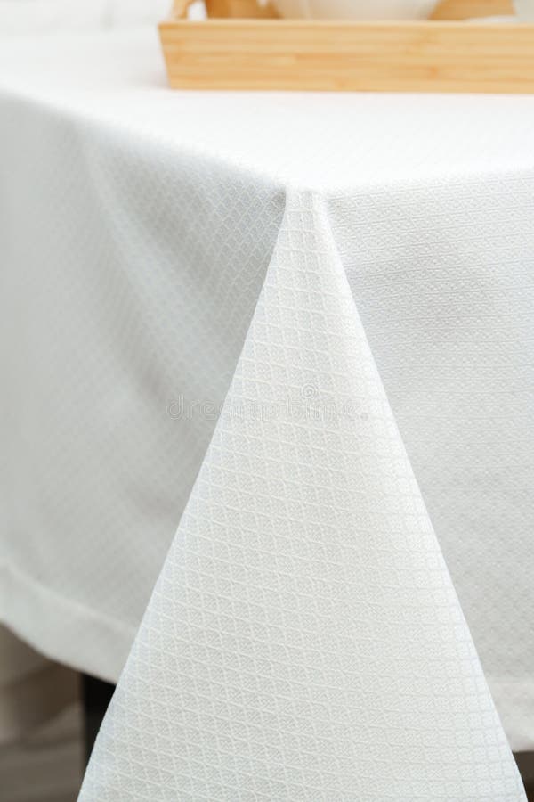 White Textured Tablecloth Draped Over Black Table Leg Stock Photos ...