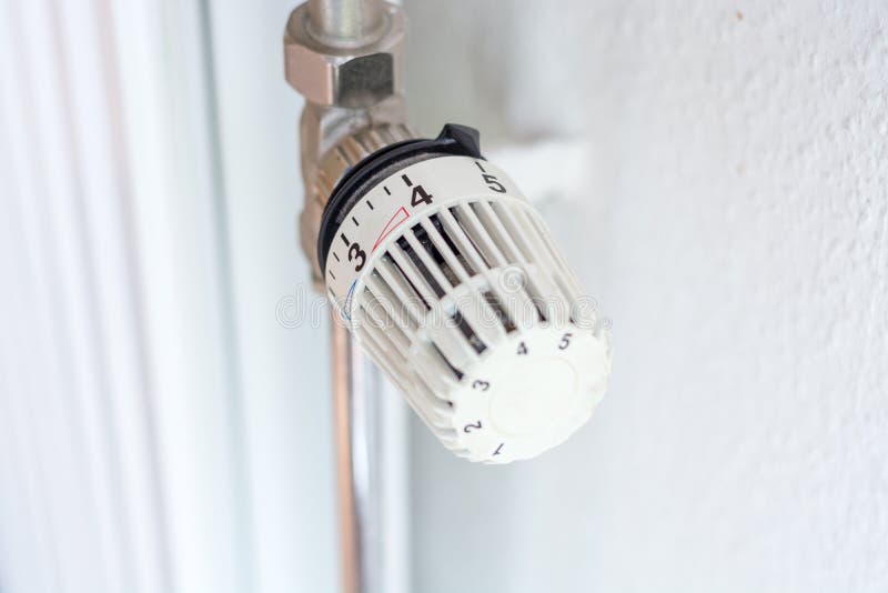 White Thermostat of a Heating Set on High Stock Photo - Image of room ...