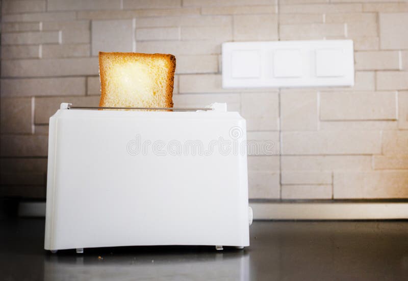 White Toaster with Ready Toasted Slice of Bread in the Kitchen ...