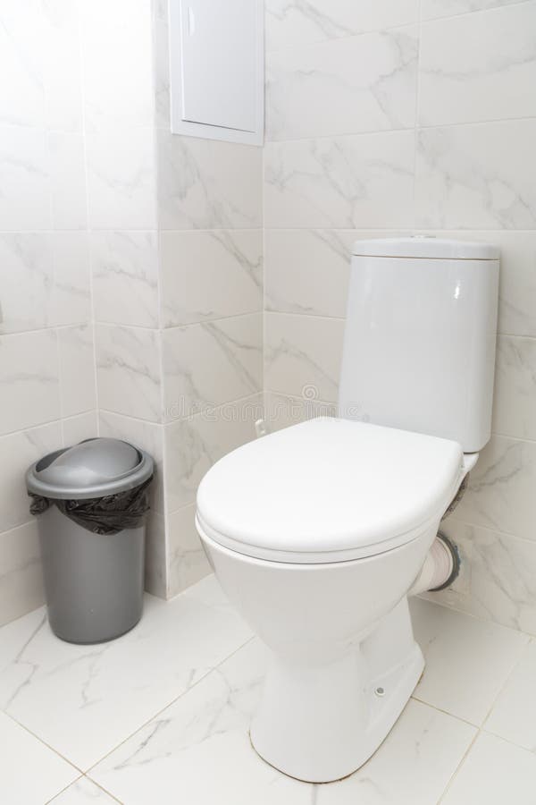 White Toilet Against a White Wall in the Bathroom Stock Photo - Image ...