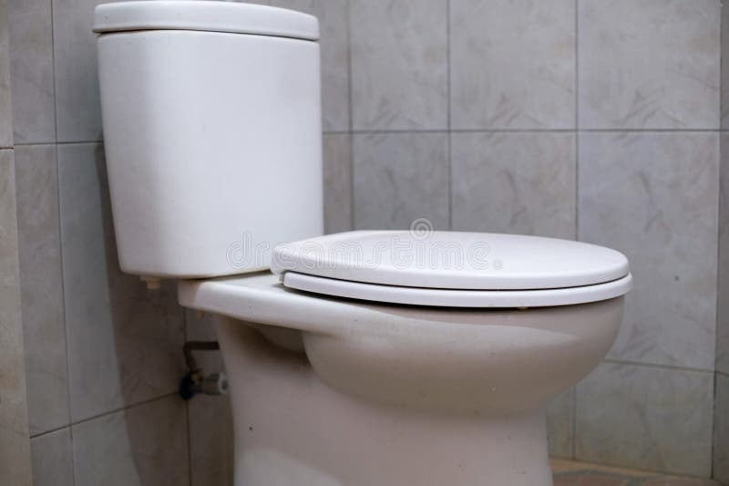 White Toilet with Open Lid in Bathroom with Ceramic Wall Stock Photo ...