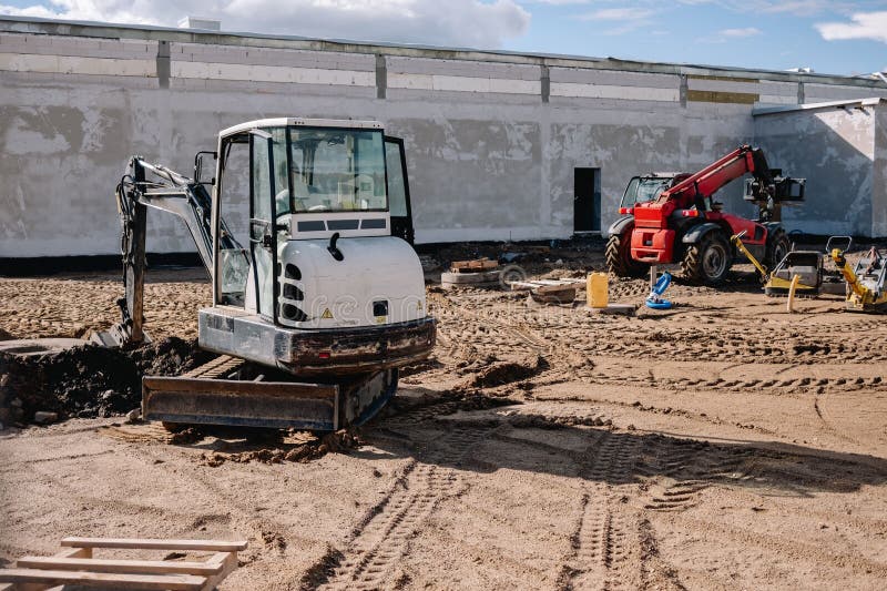 White Tractor Working in a Construction Site Stock Image - Image of ...