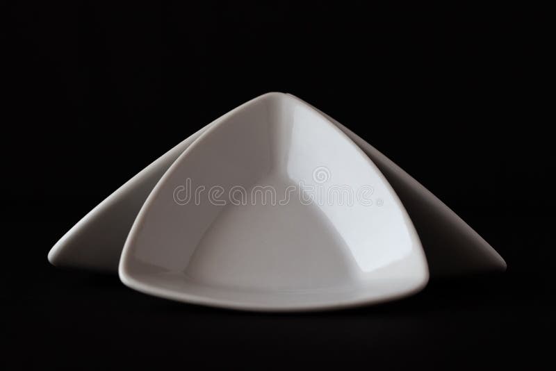 White Triangular Ceramic Bowls with on the Black Background. Stock ...