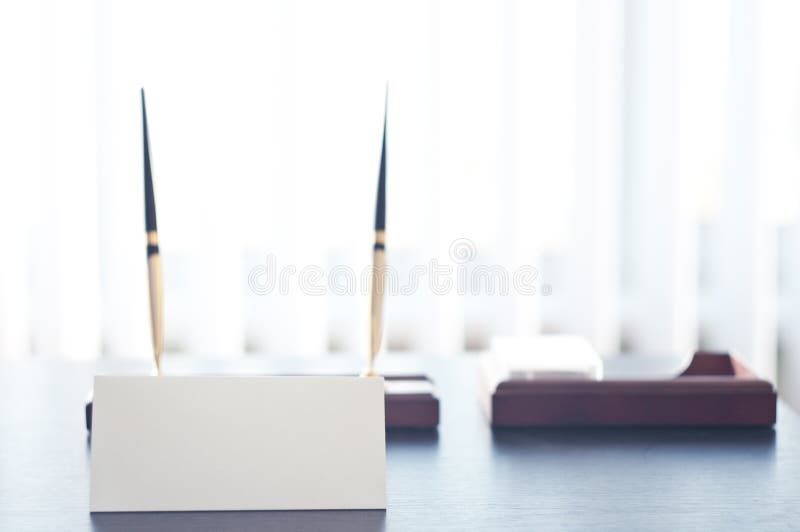 White Triangular Sign for the Label Standing on a Black Table. Stock ...