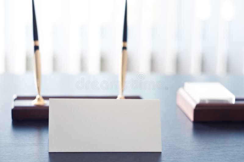 White Triangular Sign for the Label Standing on a Black Table. Stock ...