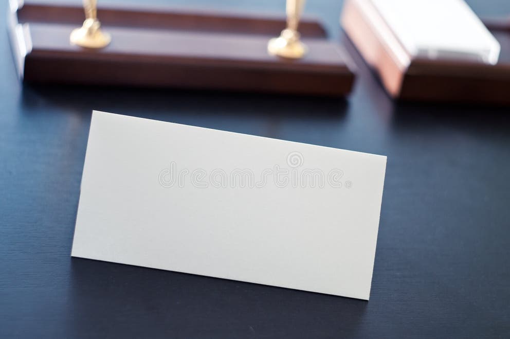 White Triangular Sign for the Label Standing on a Black Table. Stock ...
