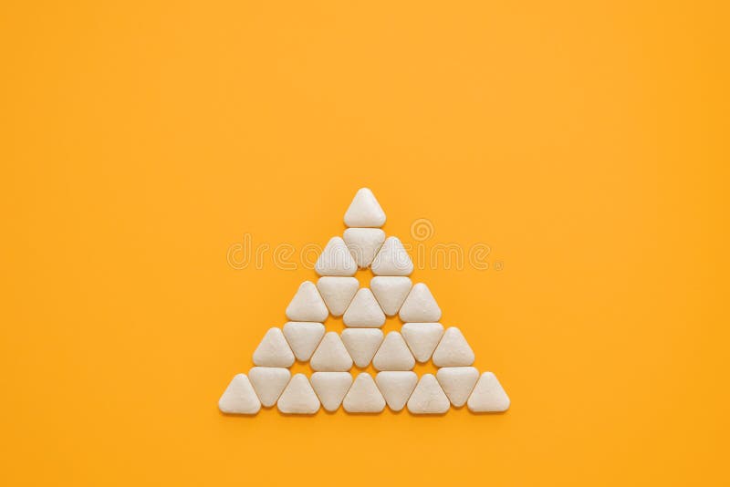 White Triangular Unusual Tablets are Laid in the Shape of a Triangle on ...
