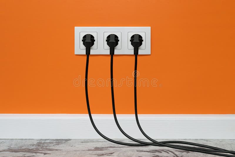 White Triple Outlet on Orange Wall Stock Photo - Image of interior ...