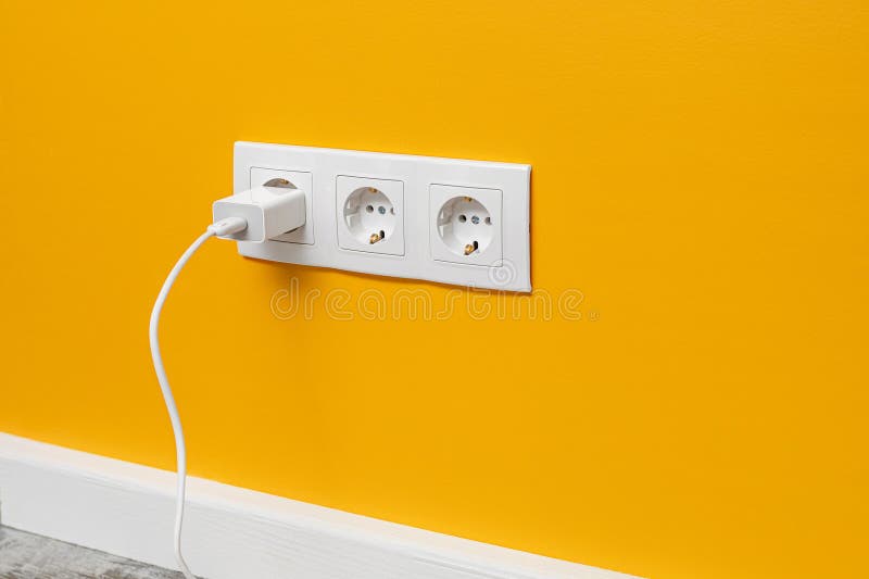 White Triple Outlet on Yellow Wall Stock Image - Image of plug, side ...