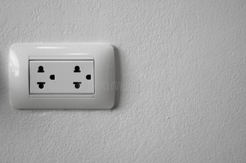 White Universal Electricity Sockets Plug on a White Wall. Stock Photo ...