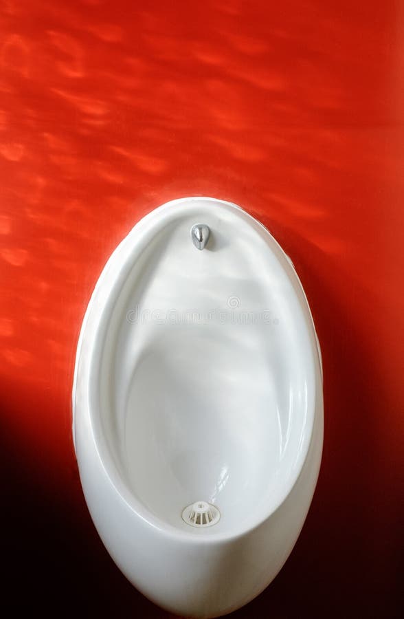 White Urinal Basin Against Red Wall Stock Photo - Image of sunlight ...
