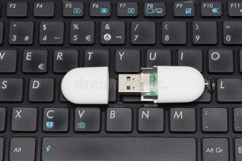 White USB Flash Drive on a Black Computer Keyboard Stock Image - Image ...