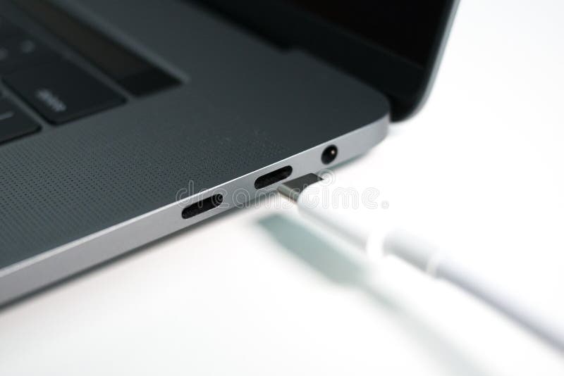 A White USB Type C / USB-C Cable Being Plugged into a Modern Notebook ...