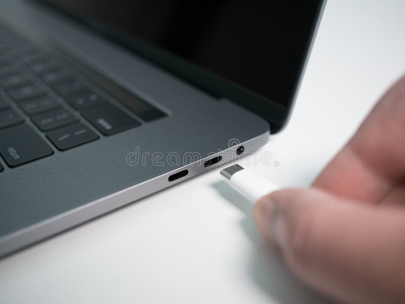 A White USB Type C / USB-C Cable Being Plugged into a Modern Notebook ...