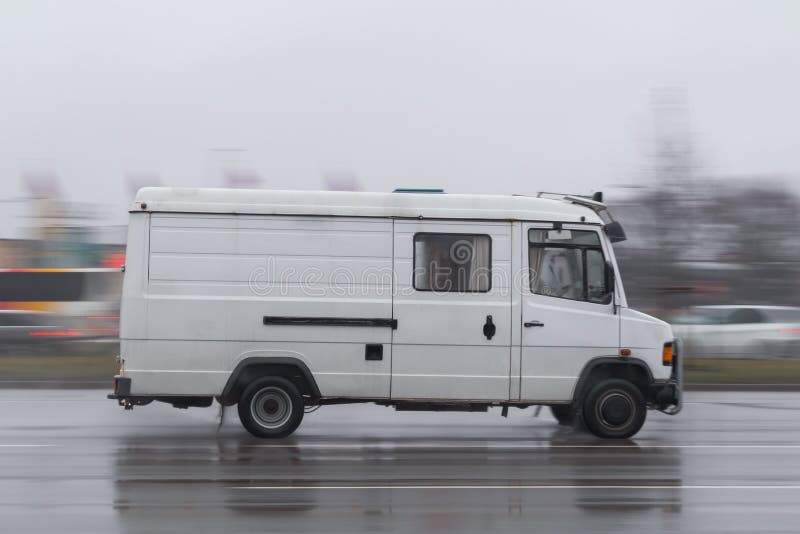 White Van Drives Down the Street in the Rain Stock Photo - Image of ...