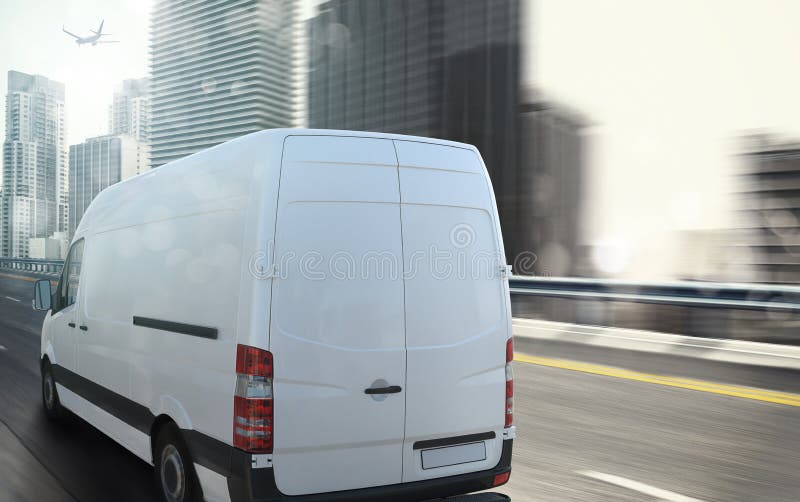 White Van Moving Fast on the Highway with a Modern City in the ...