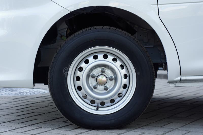 White Van Wheel with a Steel Rim, Parked on a Paved Surface Stock Image ...