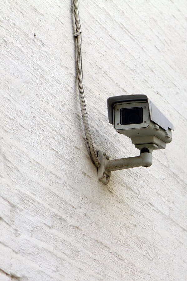 White Video Surveillance Camera on the White Dusty Wall Stock Image ...