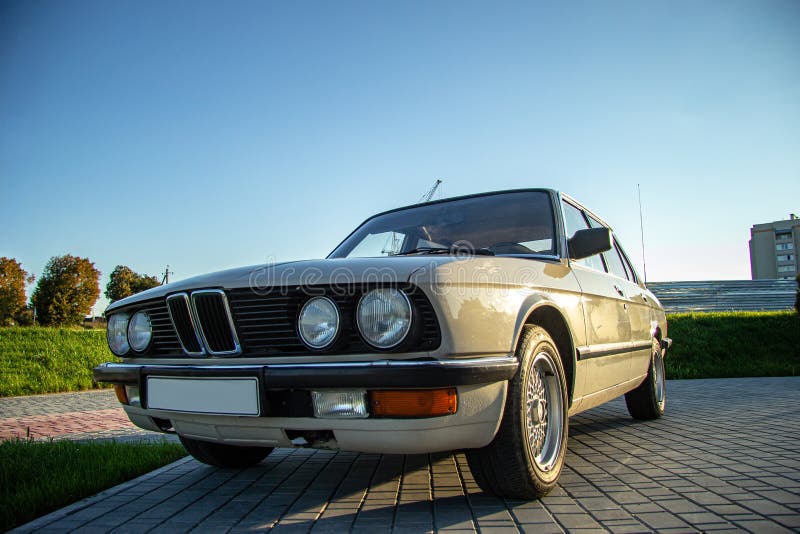 White Vintage Classic Car with Round Headlights with the Blue Sky in ...