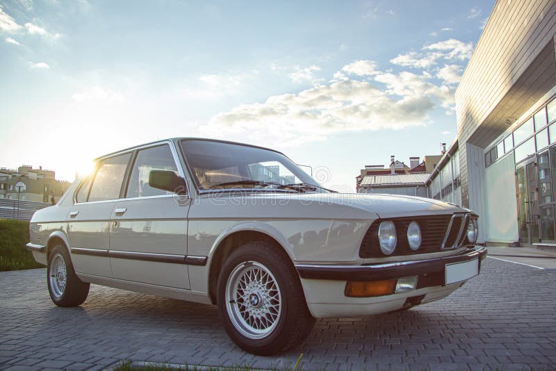 White Vintage Classic Car with Round Headlights with the Blue Sky in ...
