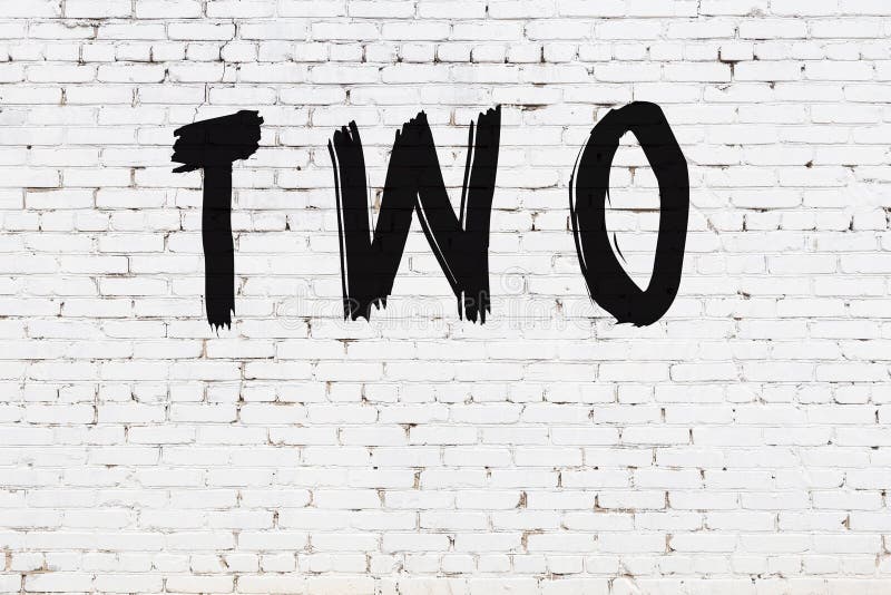 White Wall with Black Paint Inscription Two on it Stock Image - Image ...
