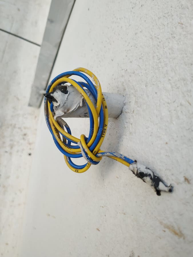 White Wall Fixed Small Plastic Pipe and Remaining Used Electrical Wires ...