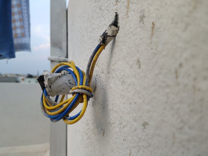 White Wall Fixed Small Plastic Pipe and Remaining Used Electrical Wires ...