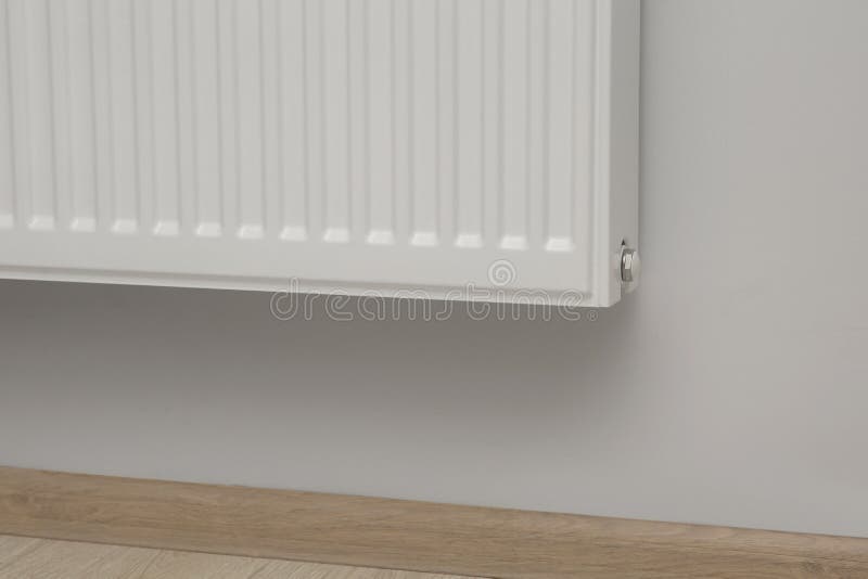 White Wall with Modern Panel Radiator Indoors. Heating System Stock ...