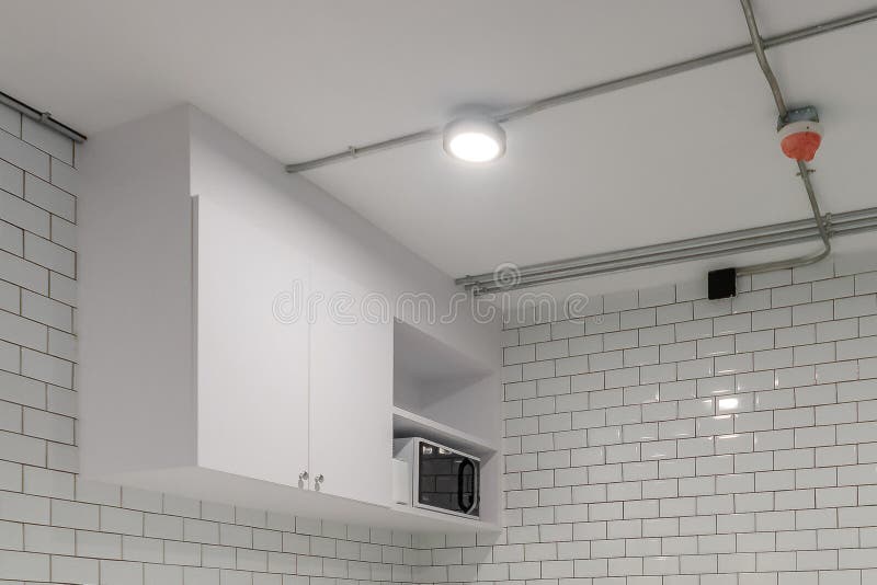 Wall-Mounted Kitchen Cabinet with a Clean White Microwave Placed Inside ...