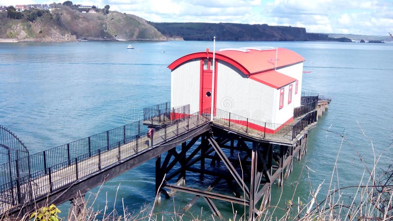 A White-walled, Red-roofed Building on a Pier at Sea Stock Photo ...