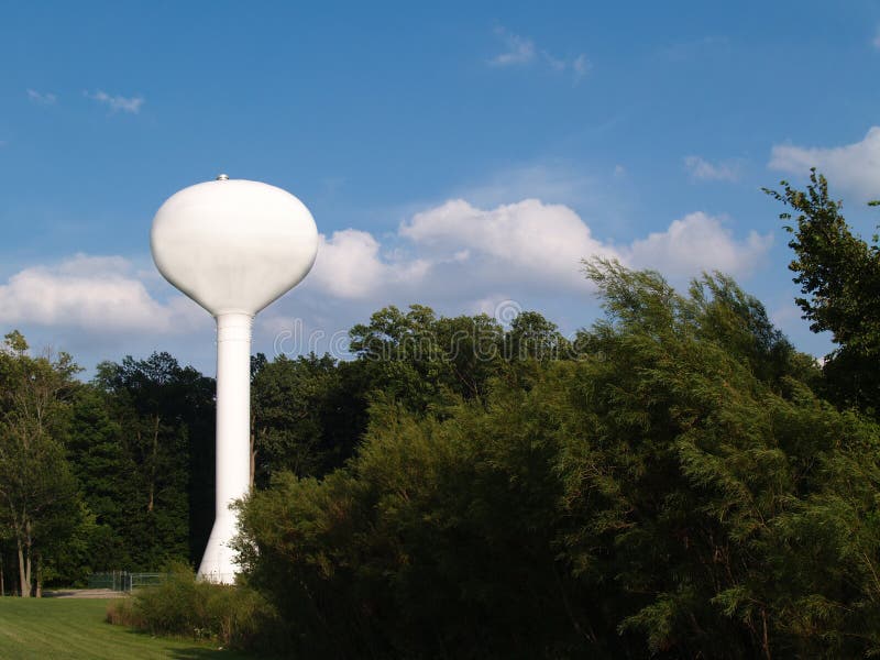 White Water Tower Against a Blue Sky Stock Photo - Image of tree, blue ...
