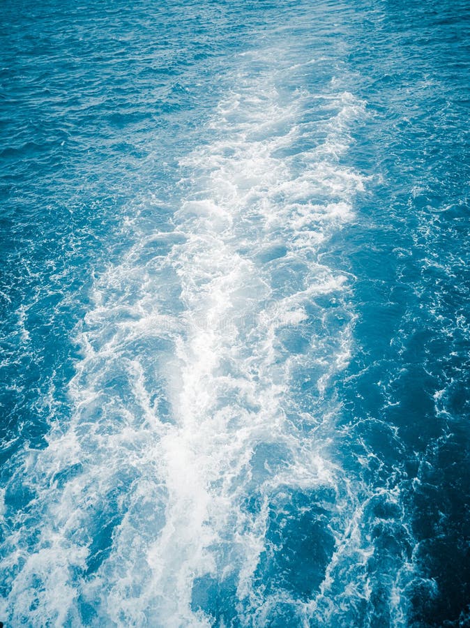 A White Wave and Foam on Blue Water, a Divergent Trail from the Boat ...