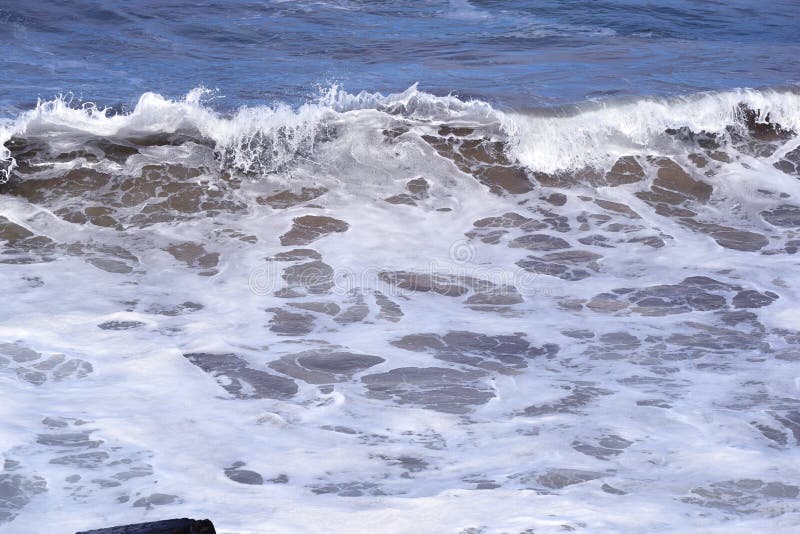 White waves on the beach stock image. Image of linear - 132200219
